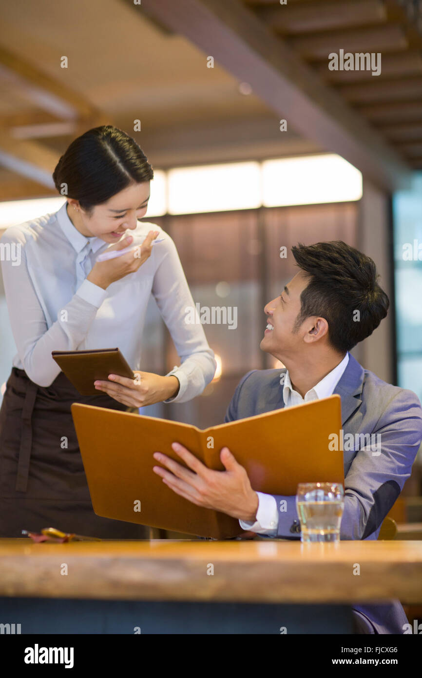 Young Chinese man ordering in restaurant Stock Photo - Alamy