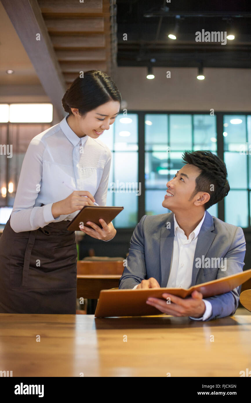 Young Chinese man ordering in restaurant Stock Photo - Alamy