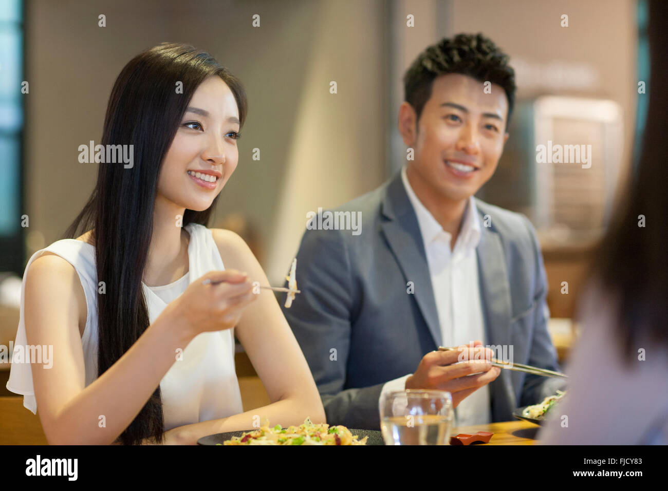Young Chinese woman having dinner with friends Stock Photo - Alamy