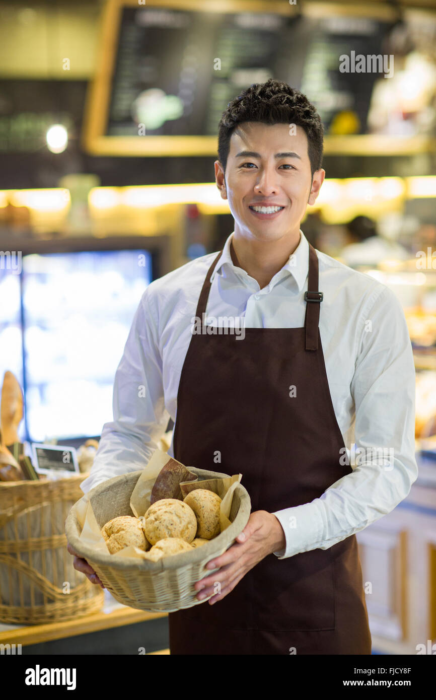 Young Chinese man working in bakery Stock Photo - Alamy
