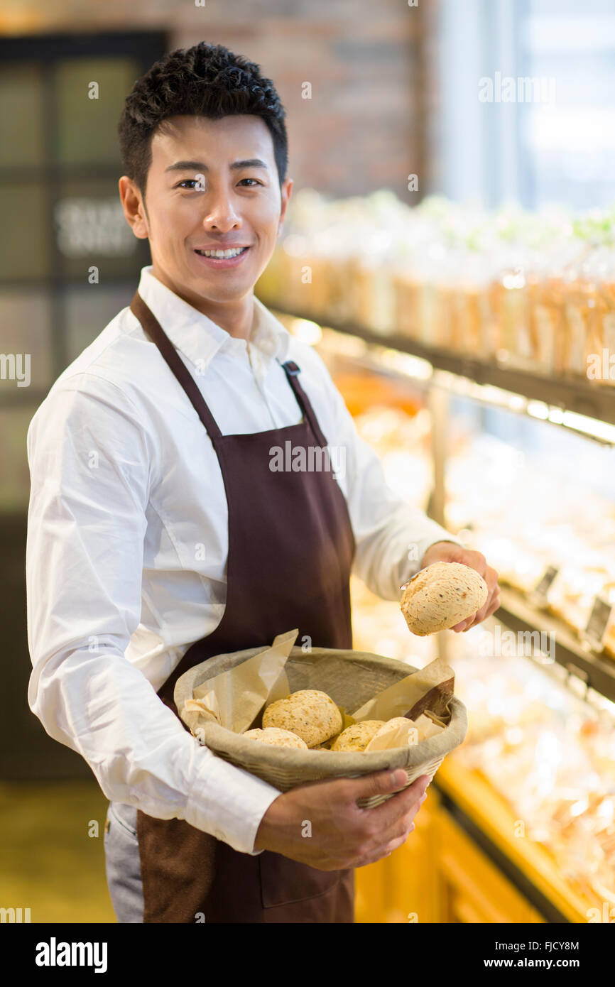 Young Chinese man working in bakery Stock Photo - Alamy