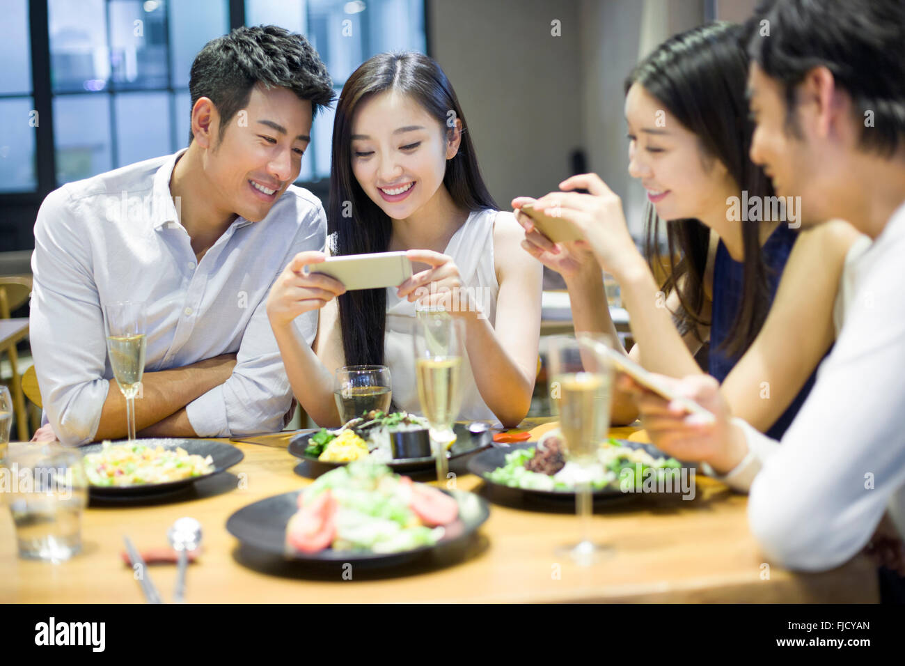 Four friends having dinner top hi-res stock photography and images - Alamy