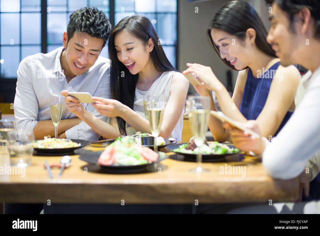 Chinese friends having dinner together Stock Photo - Alamy
