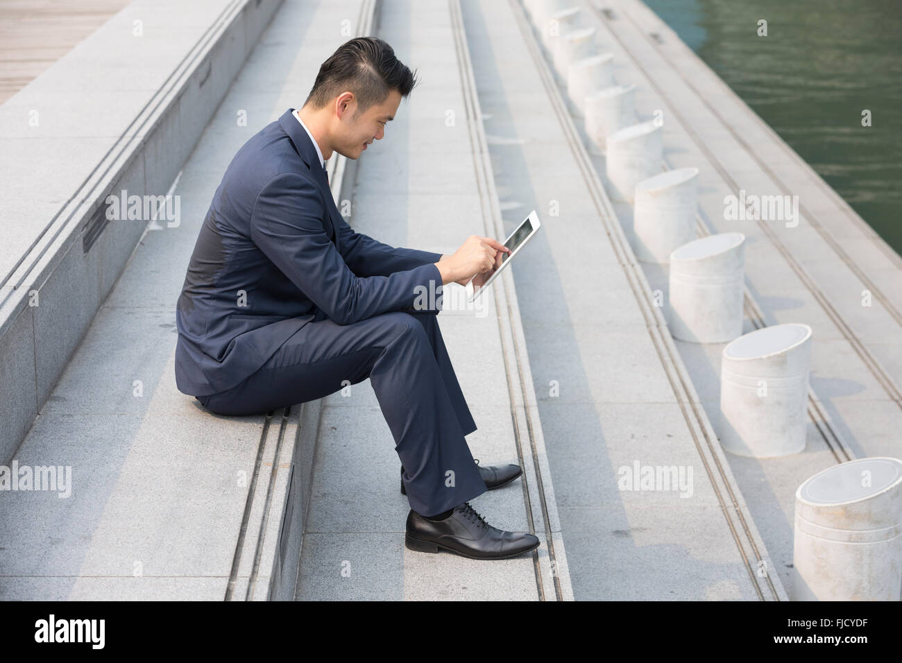 Chinese man with a tablet computer. Asian business man using digital ...