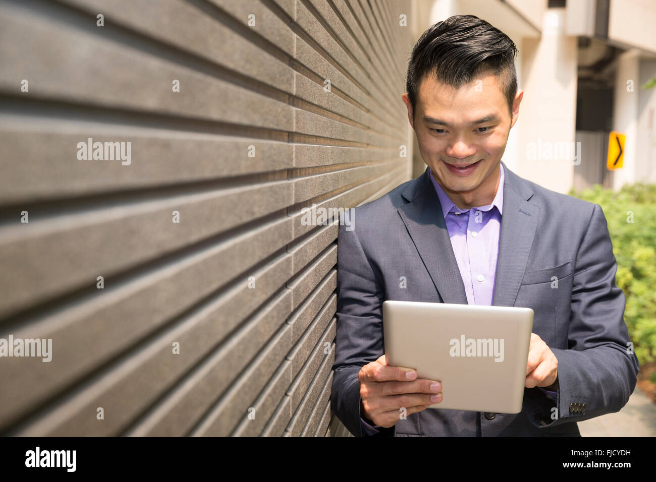 Chinese man with a tablet computer. Asian business man using digital ...