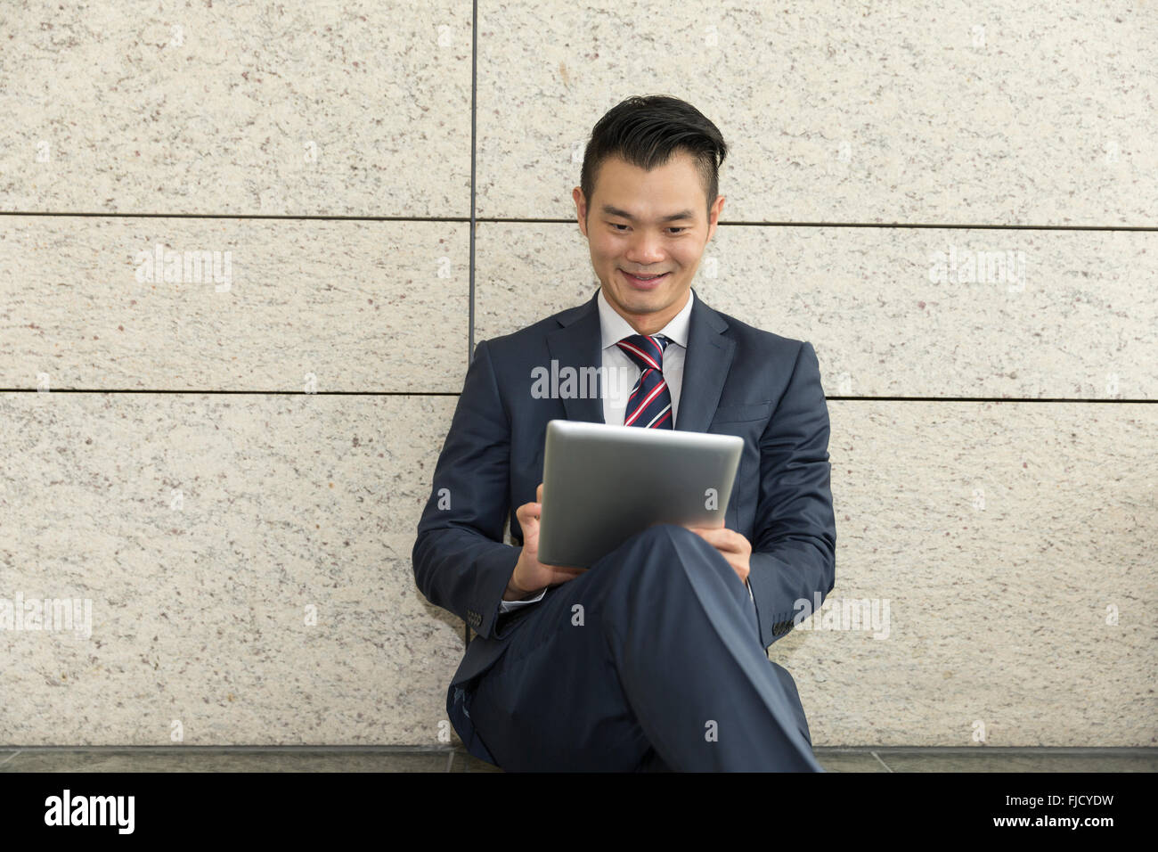 Chinese man with a tablet computer. Asian business man using digital ...