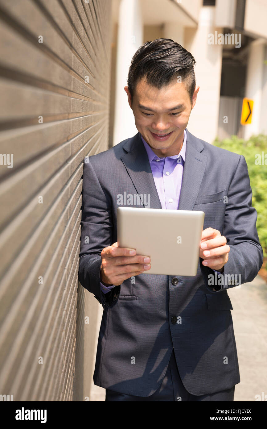 Chinese man with a tablet computer. Asian business man using digital ...