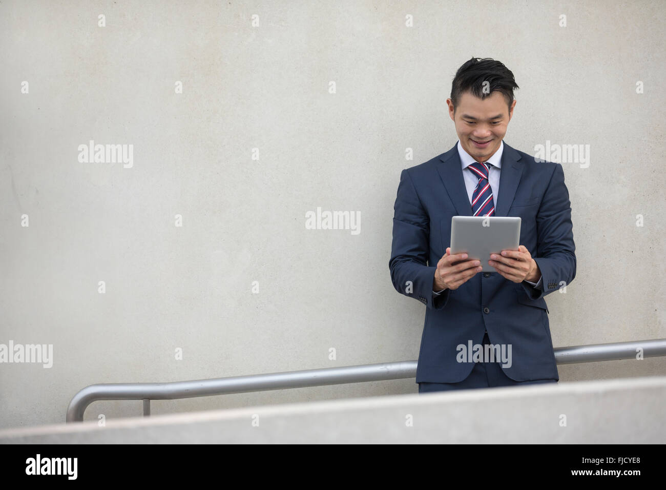 Chinese man with a tablet computer. Asian business man using digital tablet computer Stock Photo ...