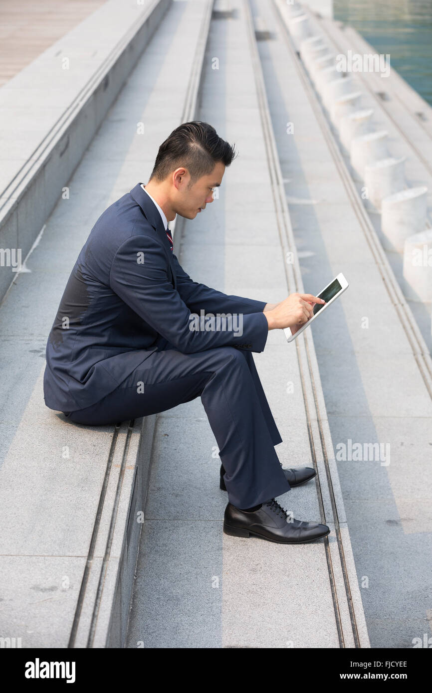 Chinese man with a tablet computer. Asian business man using digital ...