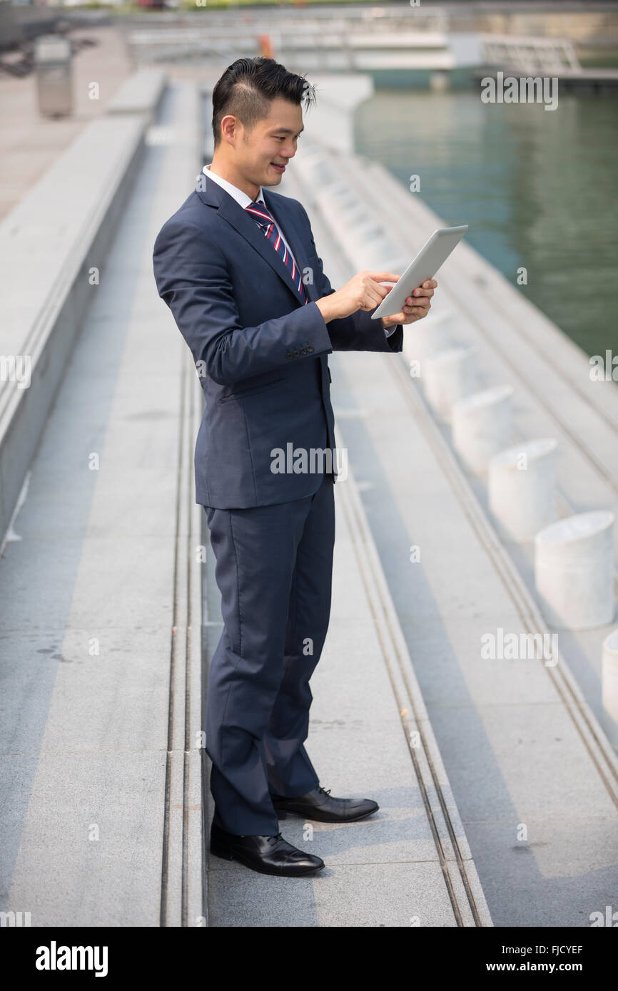 Chinese man with a tablet computer. Asian business man using digital ...