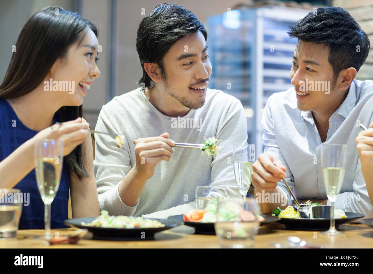 Sitting looking away communication smiling glass water food and drink ...