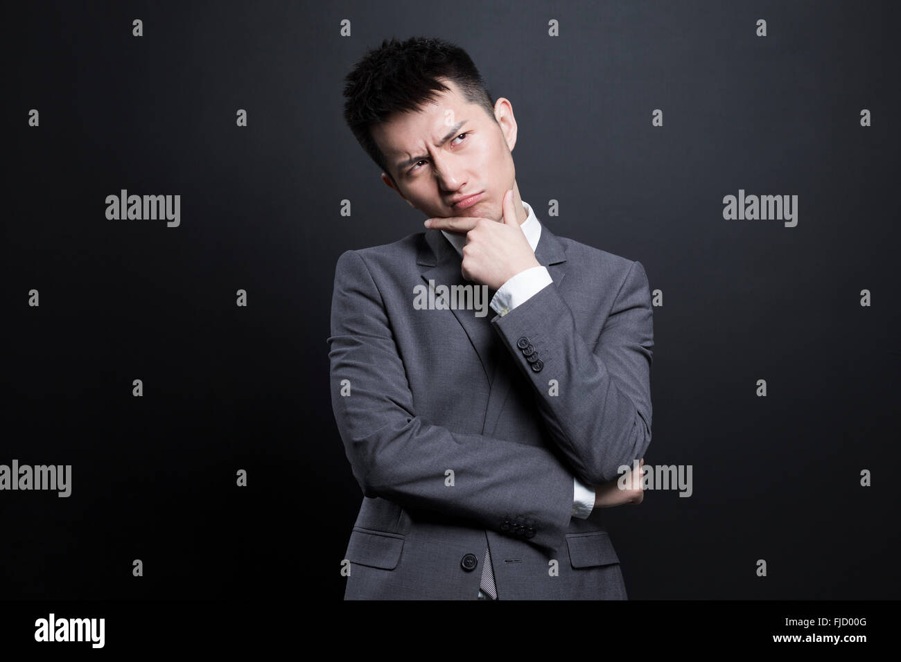 Chinese businessman thinking Stock Photo - Alamy