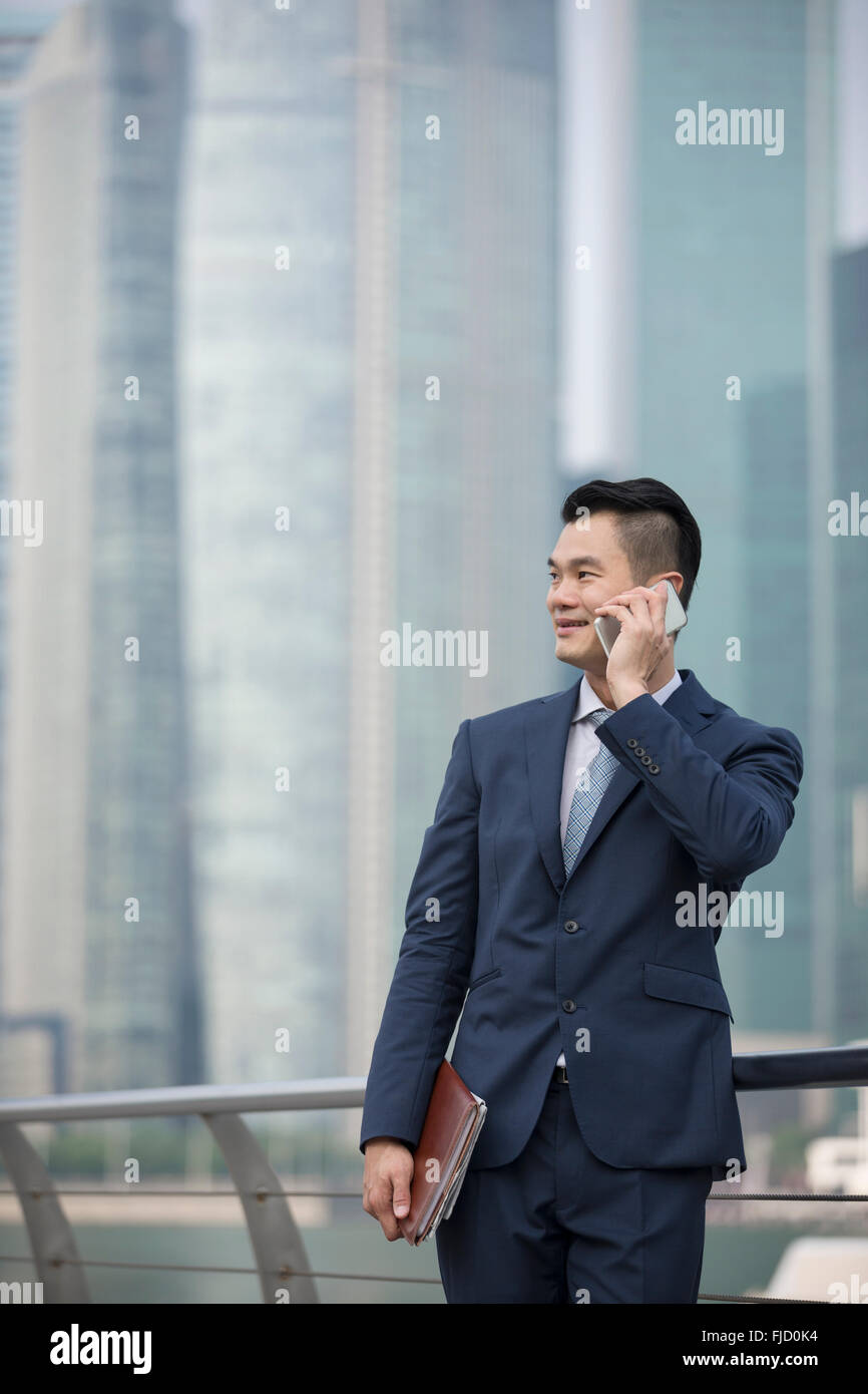 A happy Chinese business man using his smart phone Stock Photo - Alamy