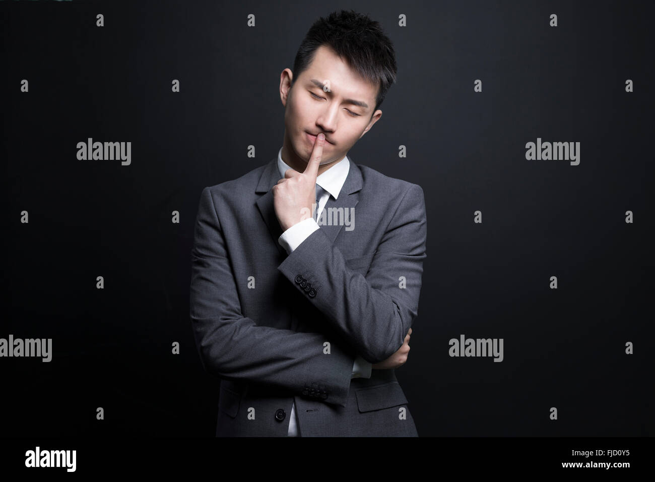 Chinese businessman thinking Stock Photo - Alamy