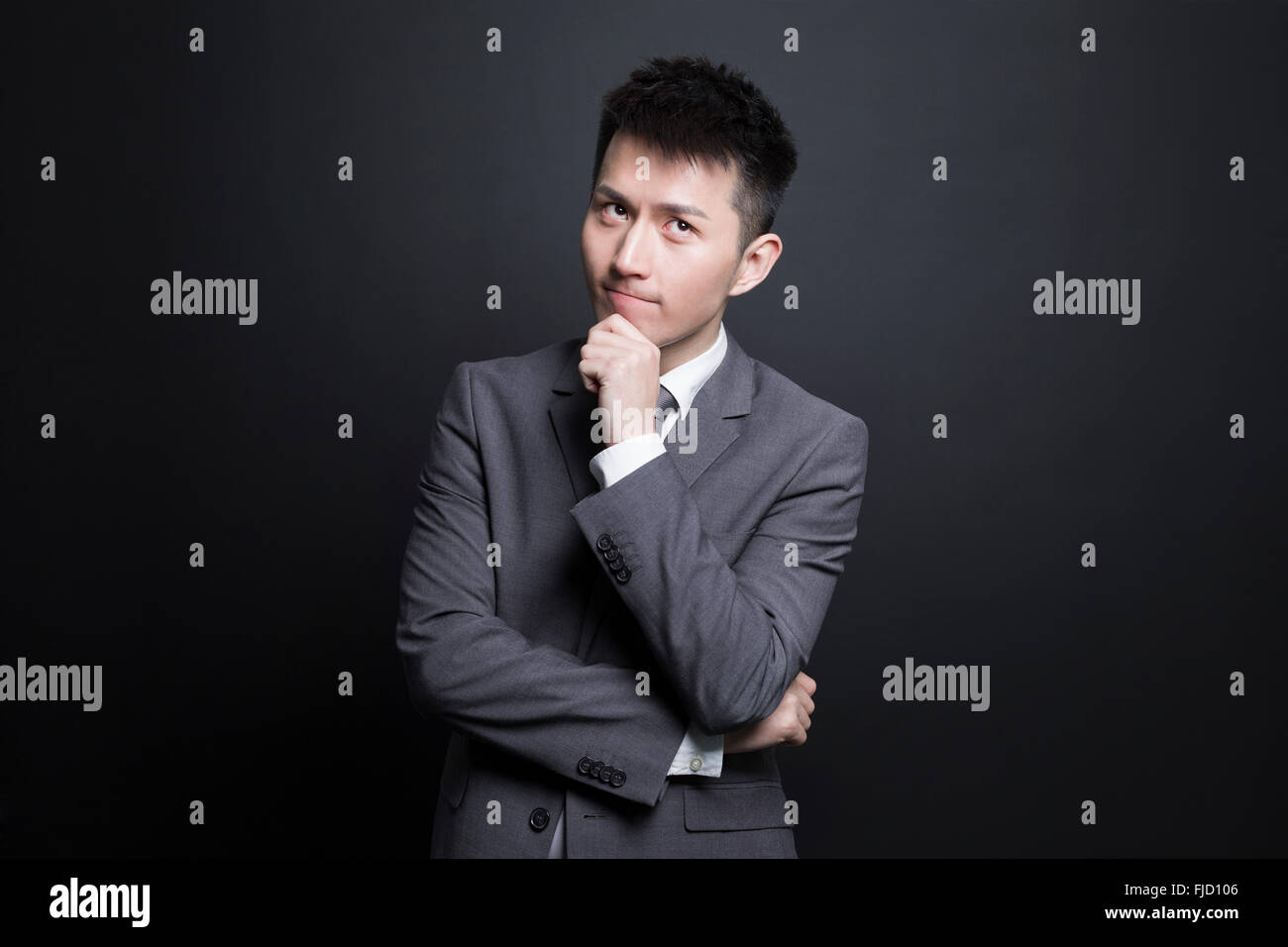 Chinese businessman thinking Stock Photo - Alamy