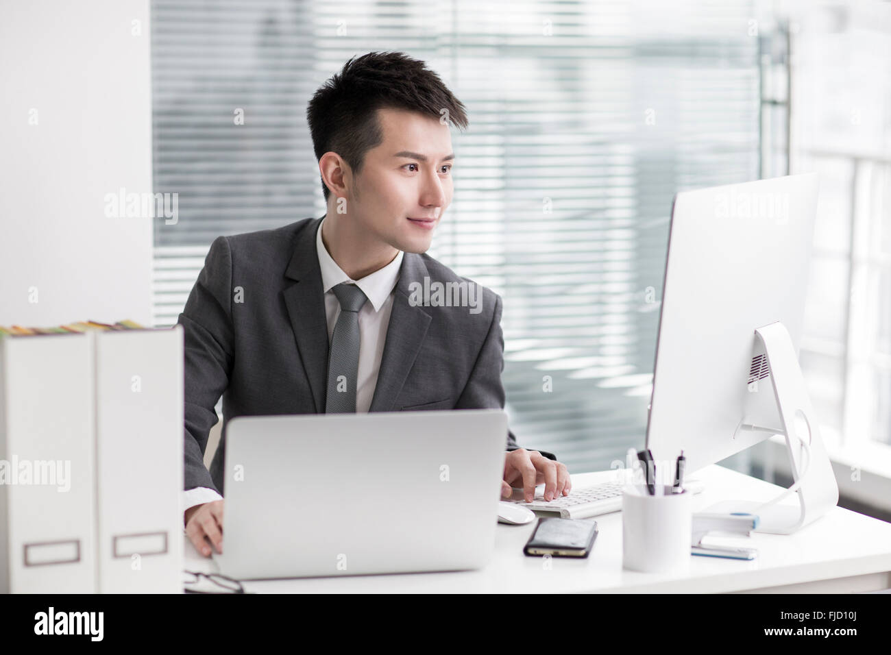 Chinese businessman working in office Stock Photo - Alamy