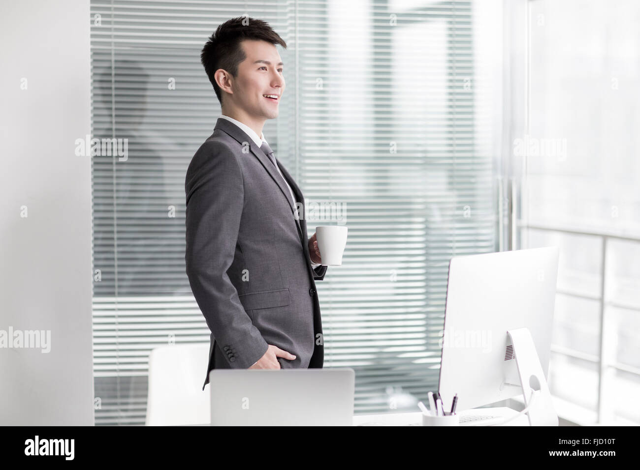 Chinese businessman taking a coffee break Stock Photo - Alamy
