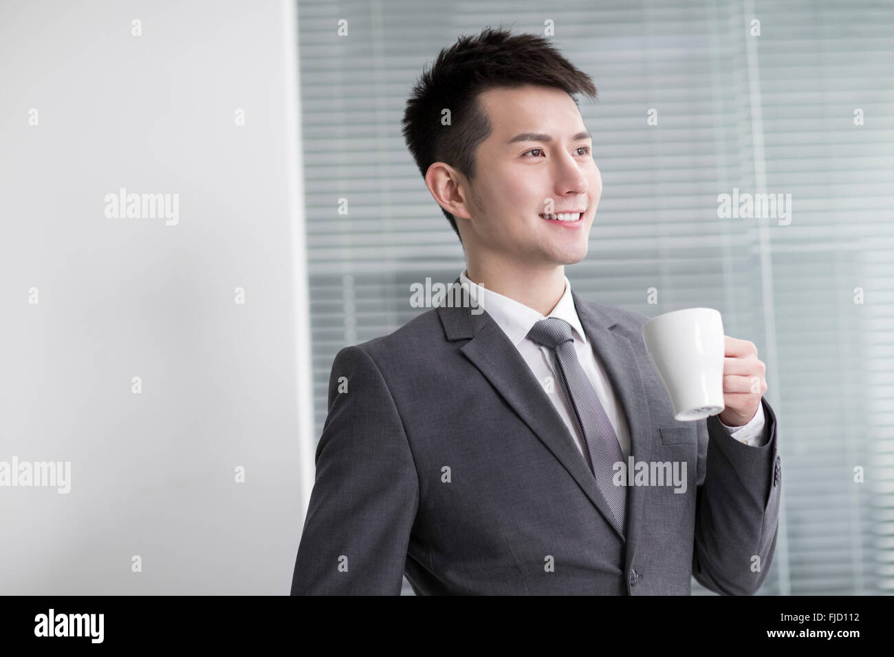 Chinese businessman taking a coffee break Stock Photo - Alamy