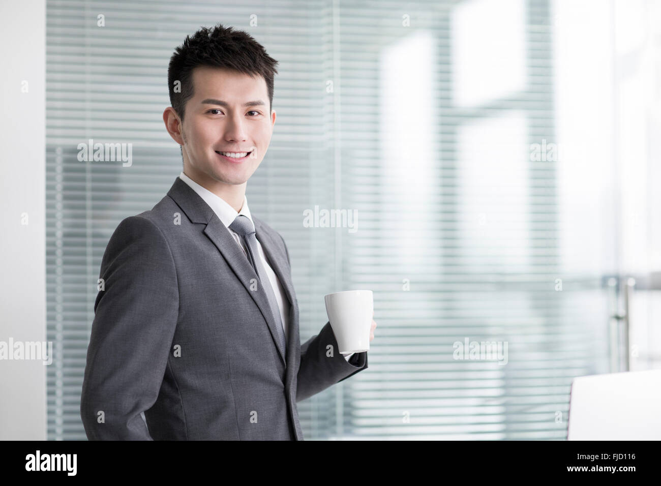 Chinese businessman taking a coffee break Stock Photo - Alamy
