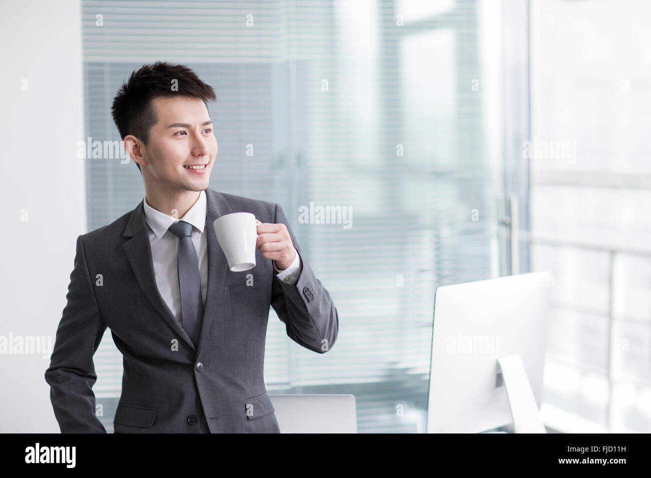Chinese businessman taking a coffee break Stock Photo - Alamy