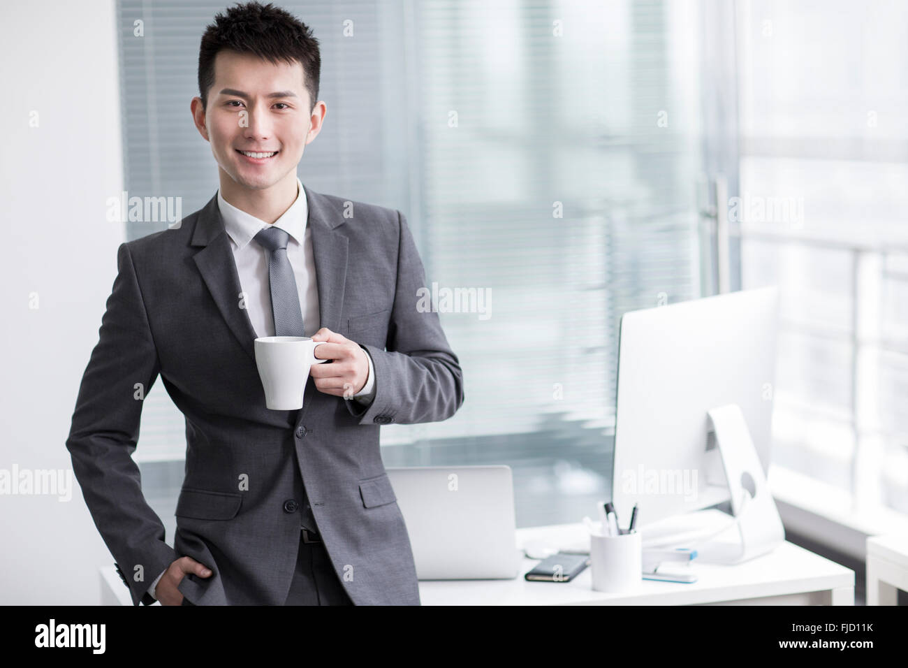 Chinese businessman taking a coffee break Stock Photo - Alamy