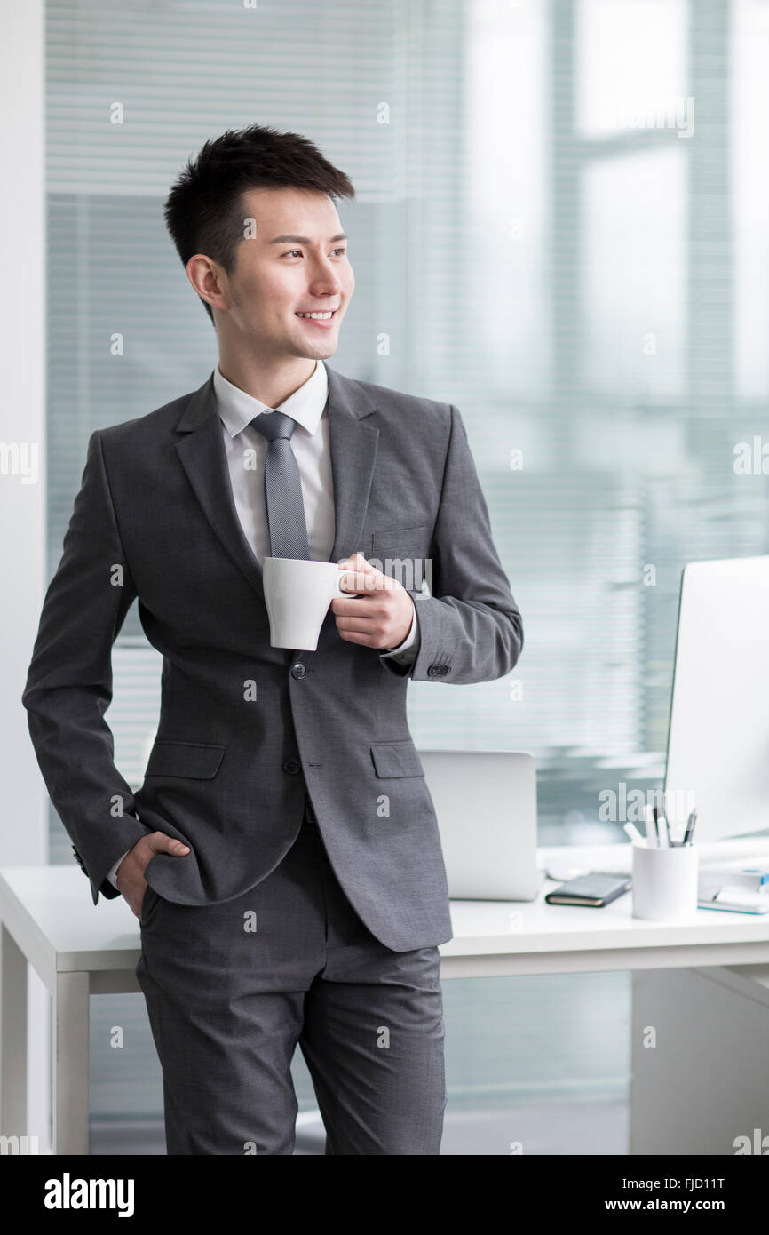 Chinese businessman taking a coffee break Stock Photo - Alamy