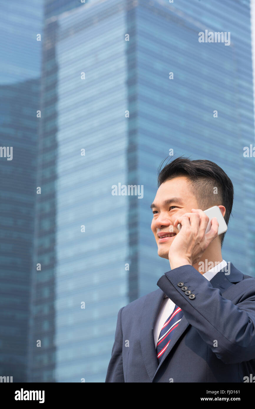 A happy Chinese business man using his smart phone Stock Photo - Alamy