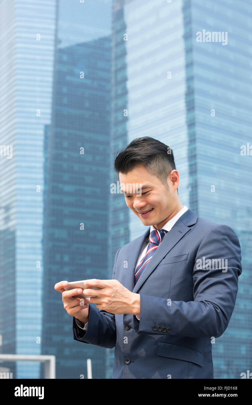 A happy Chinese business man using his smart phone Stock Photo - Alamy