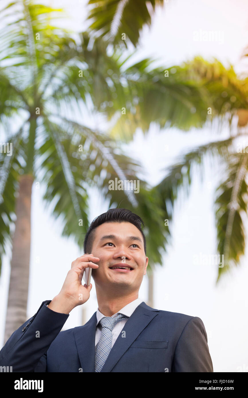 A portrait of a happy Chinese business man talking on the phone Stock ...