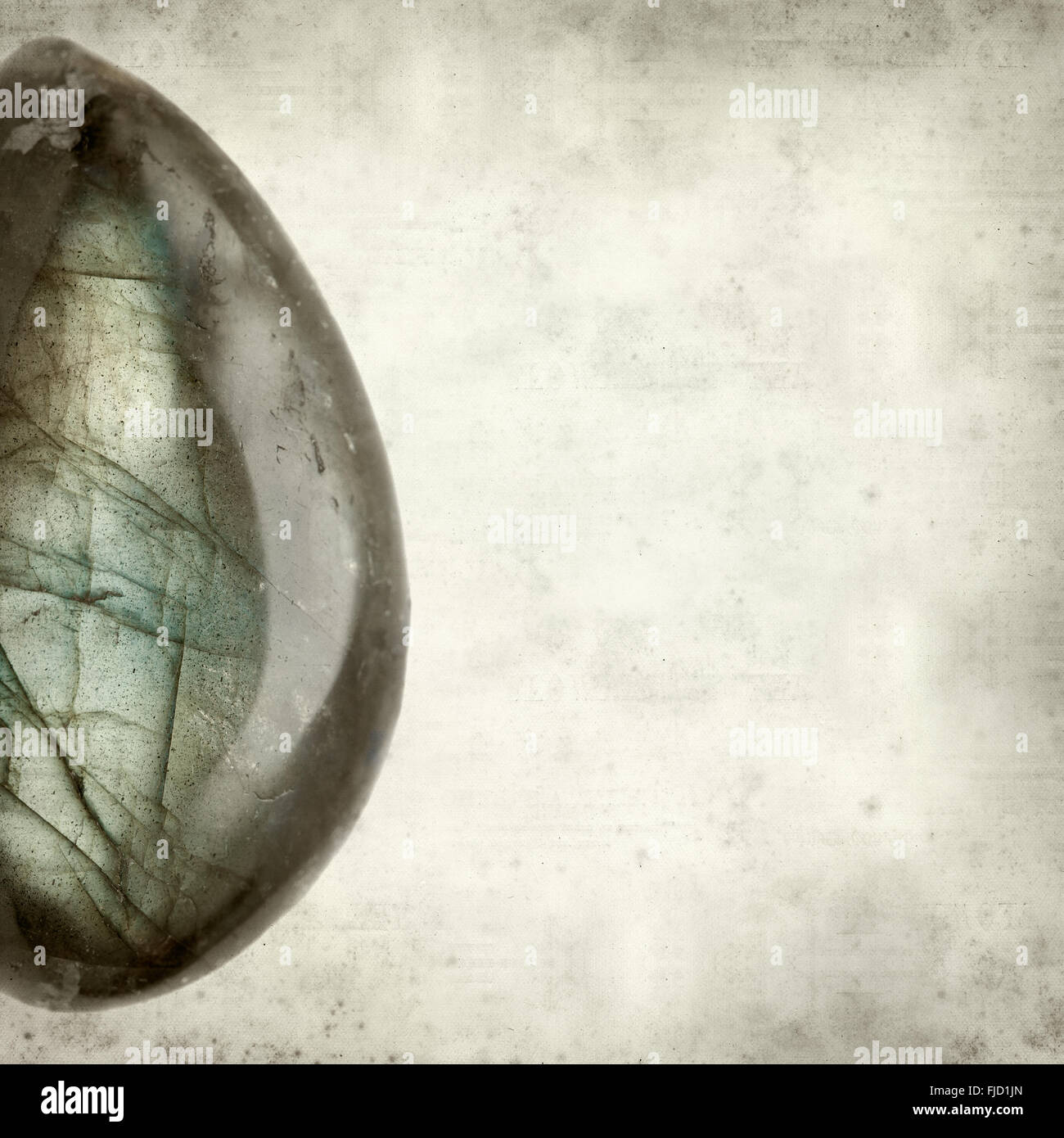 textured old paper background with spectrolite, gemstone variety of ...