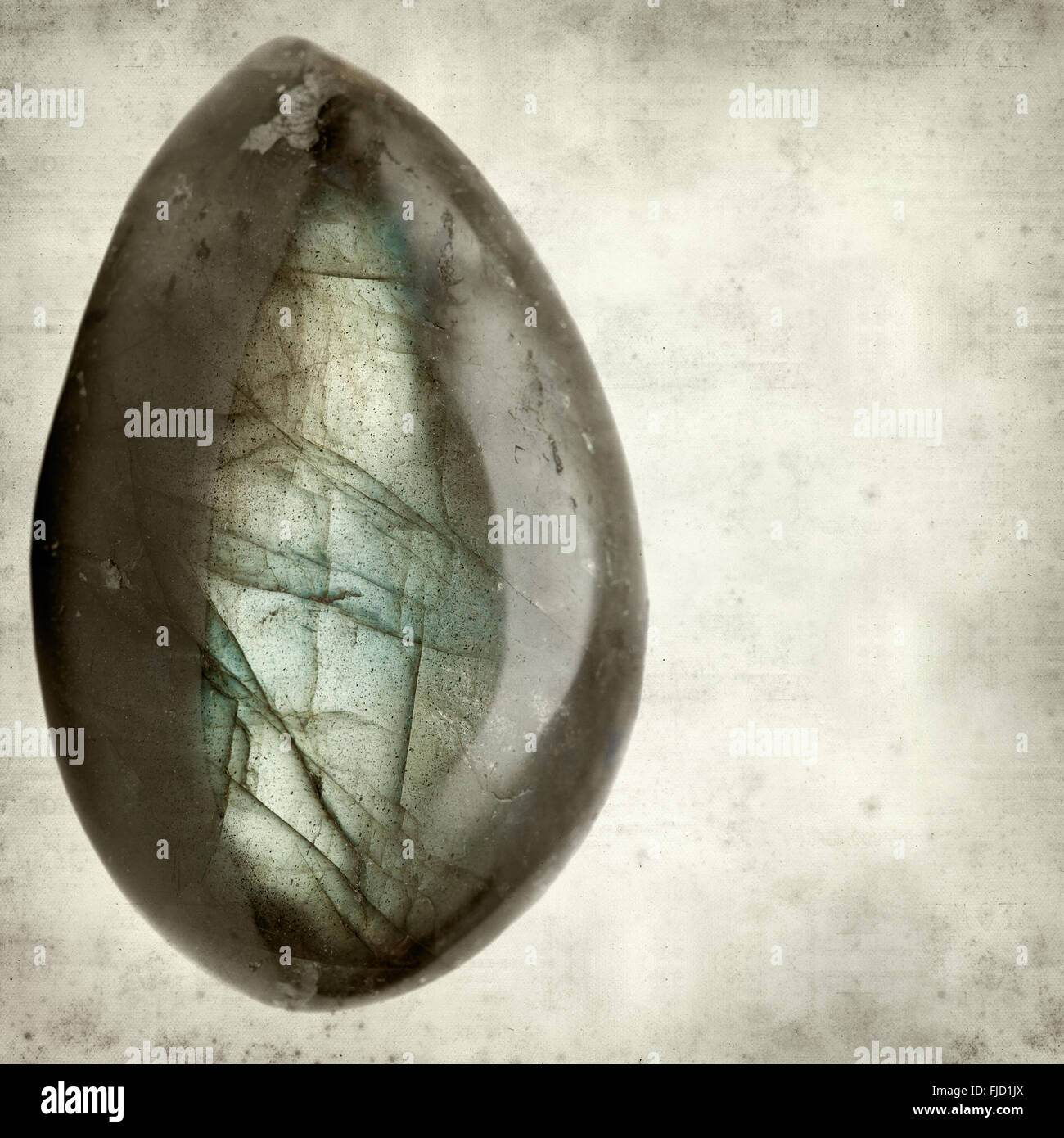 textured old paper background with spectrolite, gemstone variety of ...