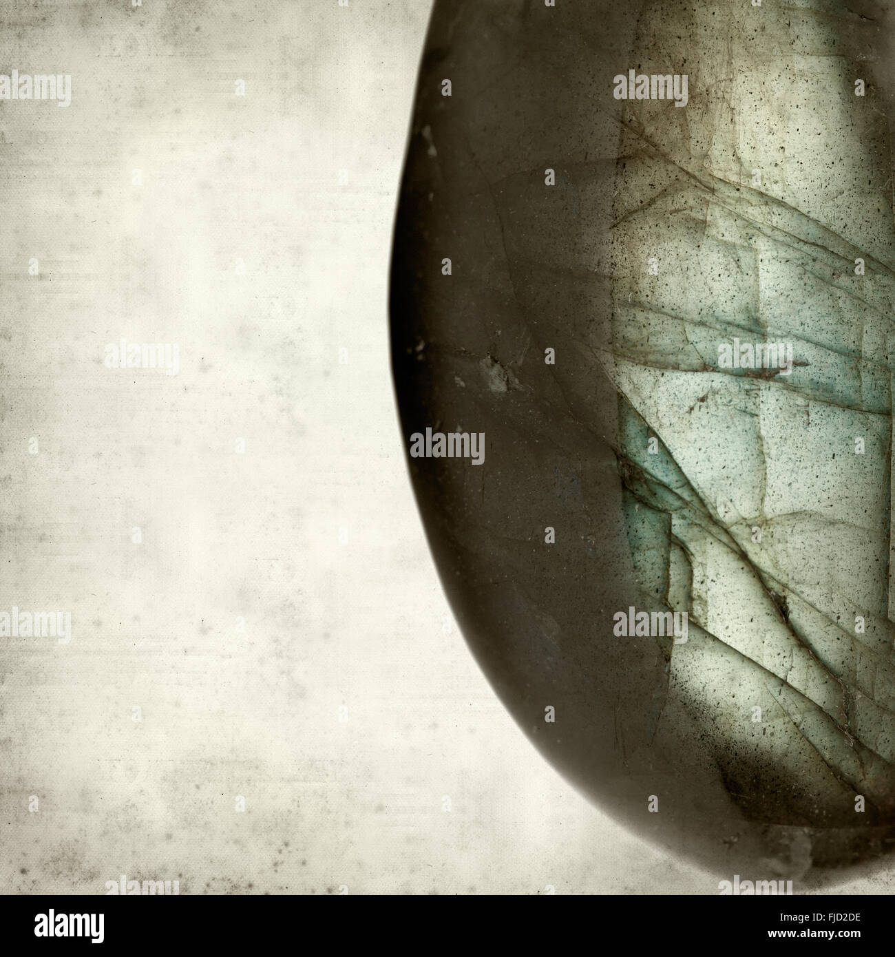 textured old paper background with spectrolite, gemstone variety of ...