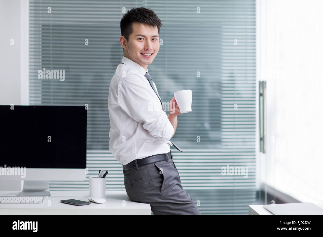 Chinese businessman taking a coffee break Stock Photo - Alamy