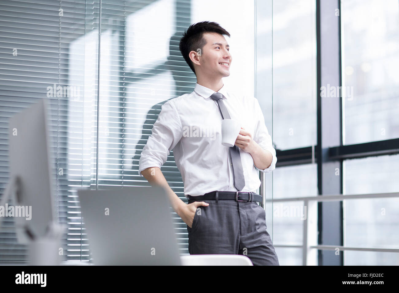 Chinese businessman taking a coffee break Stock Photo - Alamy