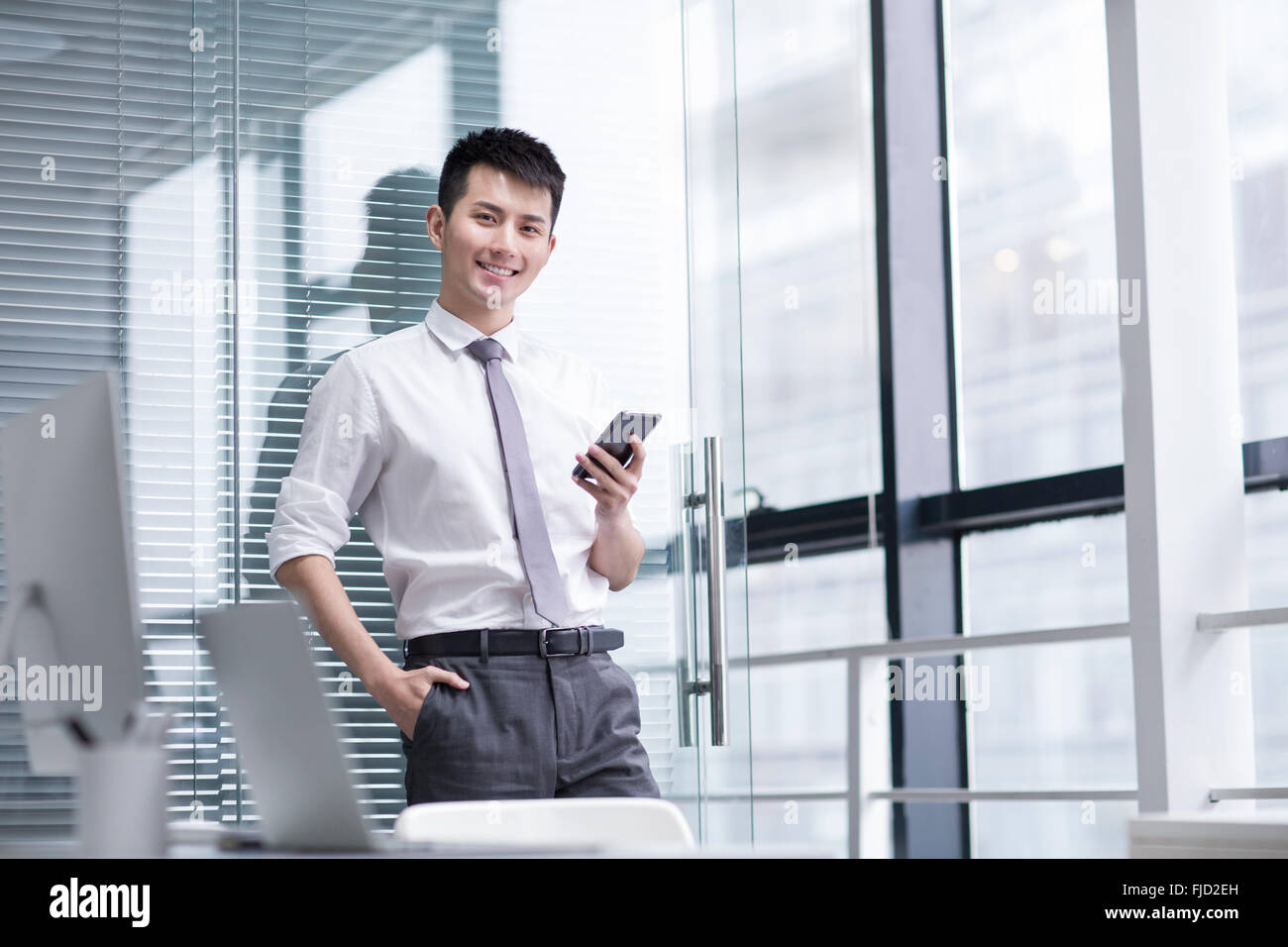 Chinese businessman using smart phone Stock Photo - Alamy