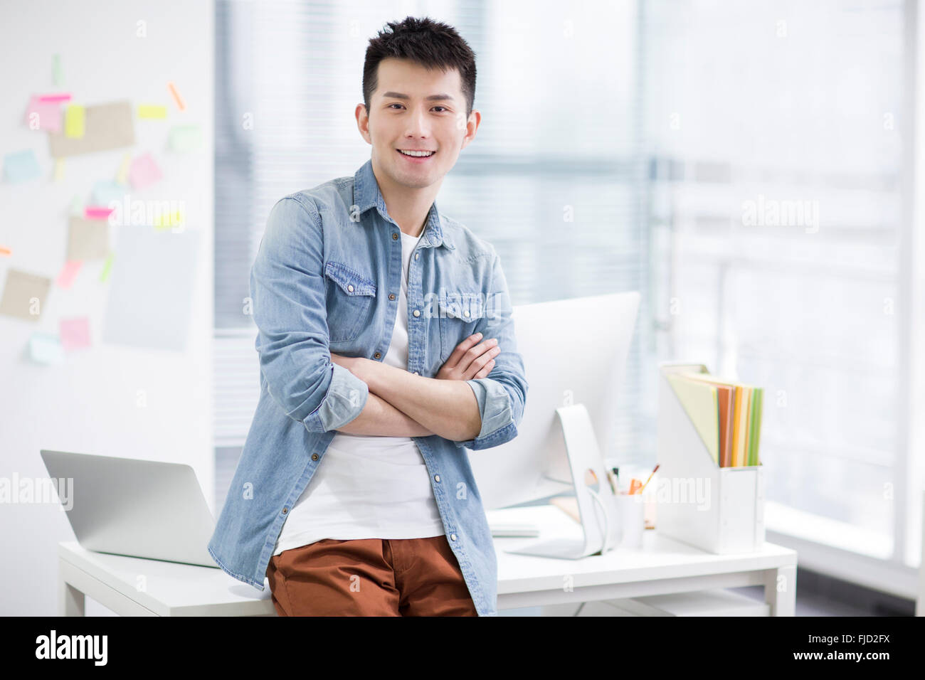 Portrait of young Chinese man in office Stock Photo - Alamy