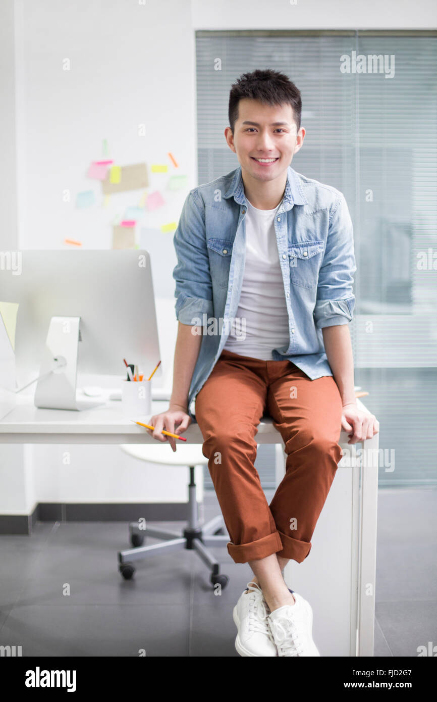 Portrait of young Chinese man in office Stock Photo - Alamy