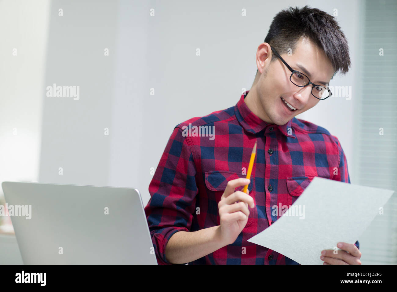 Young Chinese man working in office Stock Photo - Alamy