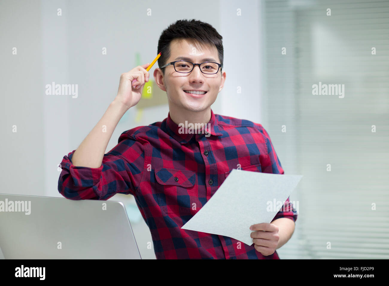 Young Chinese man working in office Stock Photo - Alamy