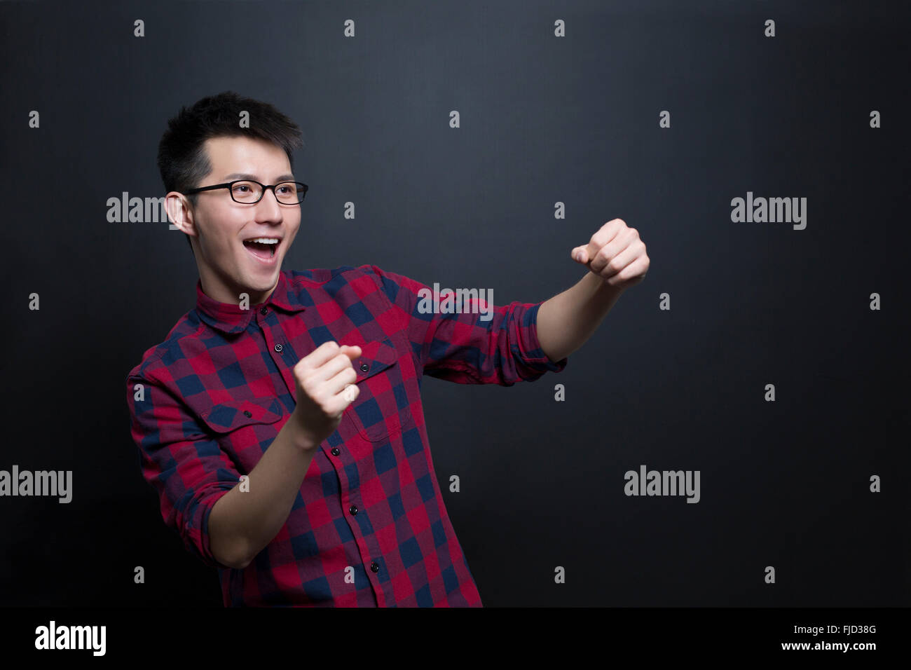 Excited Chinese man driving Stock Photo - Alamy