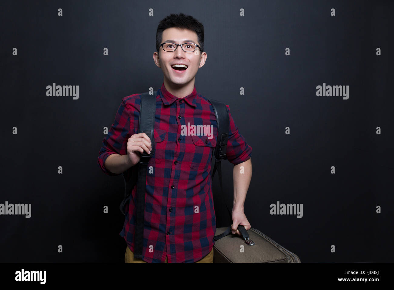 Young Chinese man running with luggage Stock Photo - Alamy