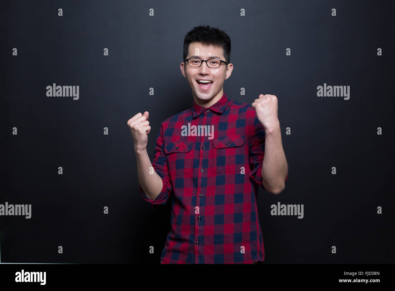 Excited young Chinese man Stock Photo - Alamy