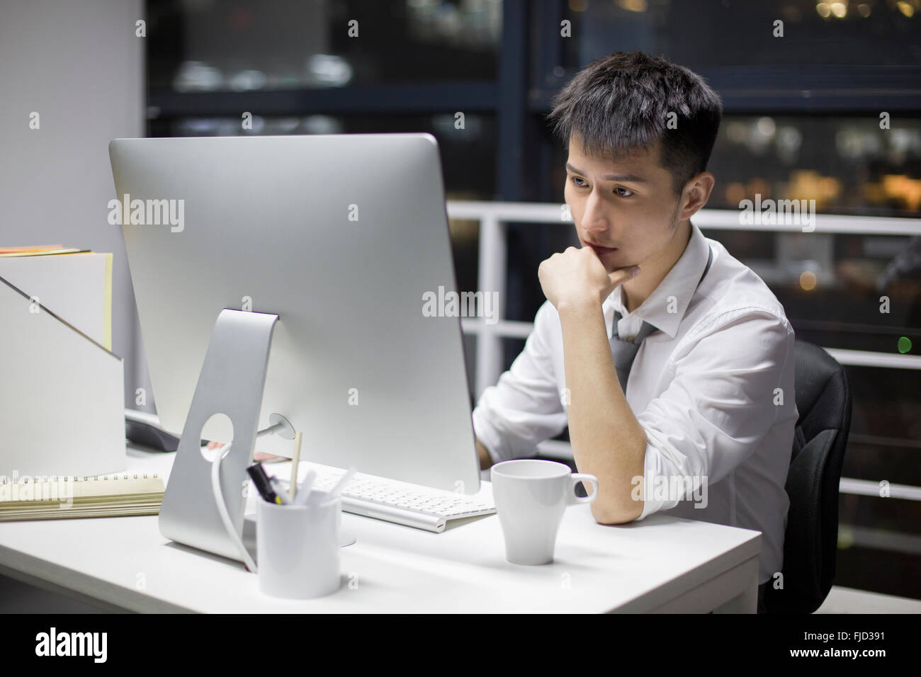 Chinese businessman working late in office Stock Photo - Alamy