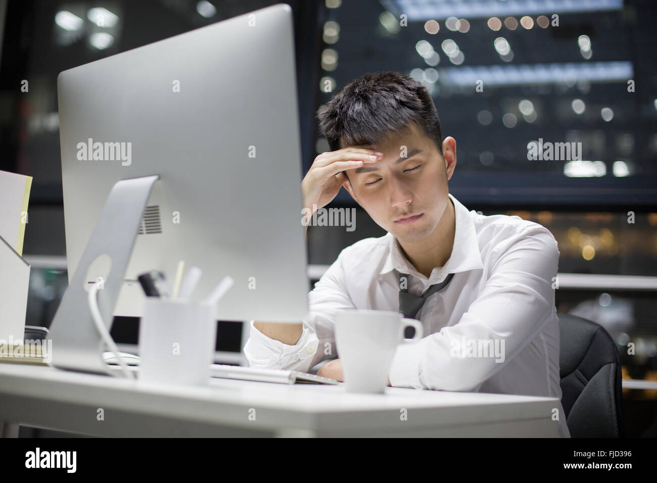 Chinese businessman working late in office Stock Photo - Alamy