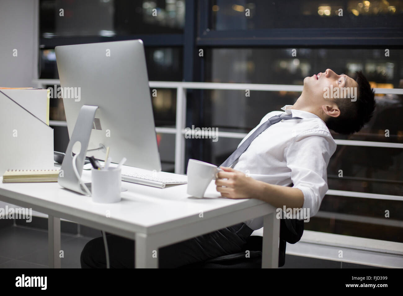 Chinese businessman working late in office Stock Photo - Alamy