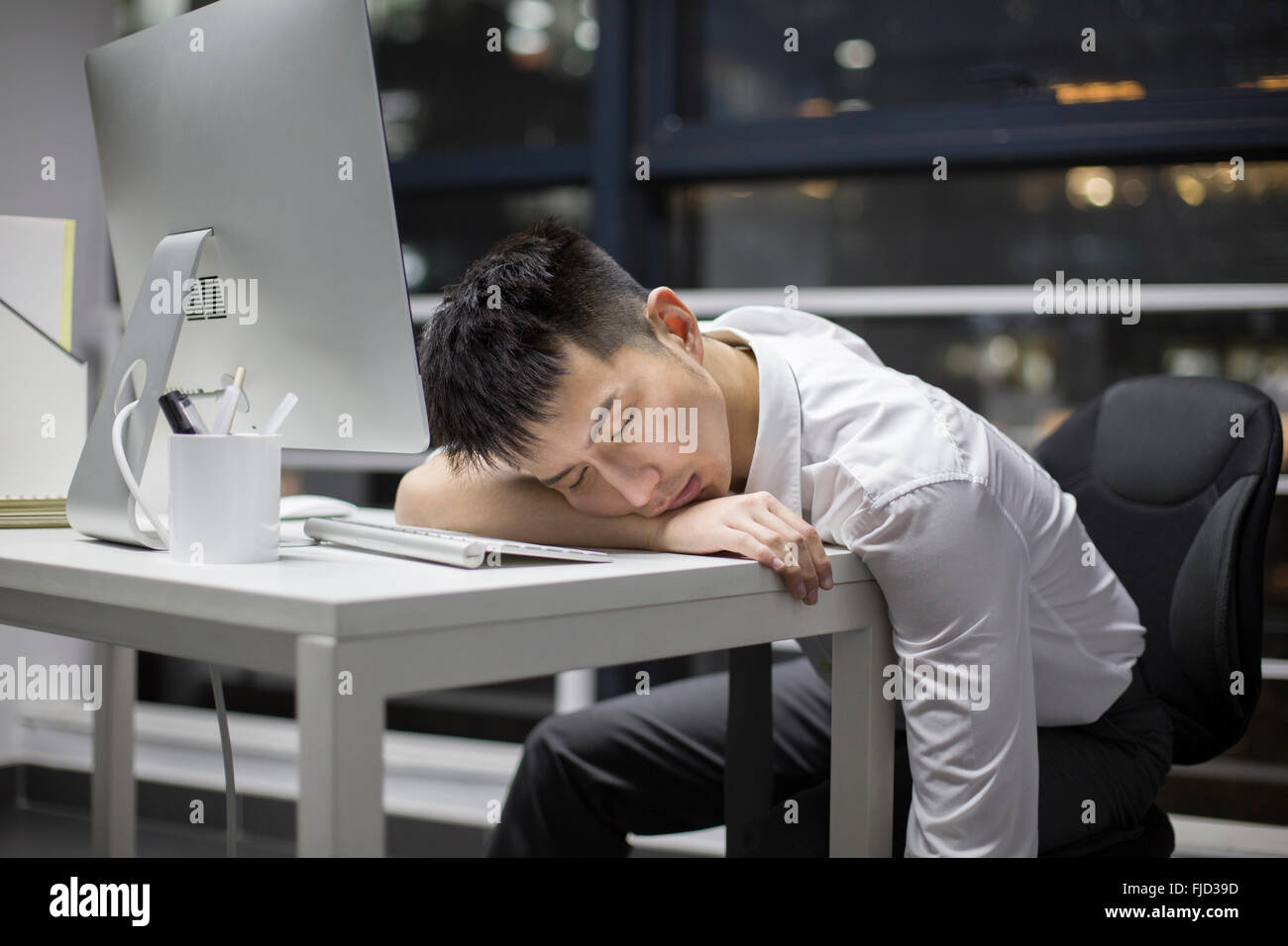 Chinese businessman working late in office Stock Photo - Alamy