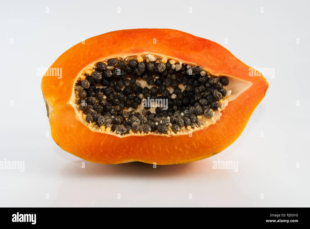 Fresh papaya cut in half on white background. Closeup Stock Photo - Alamy