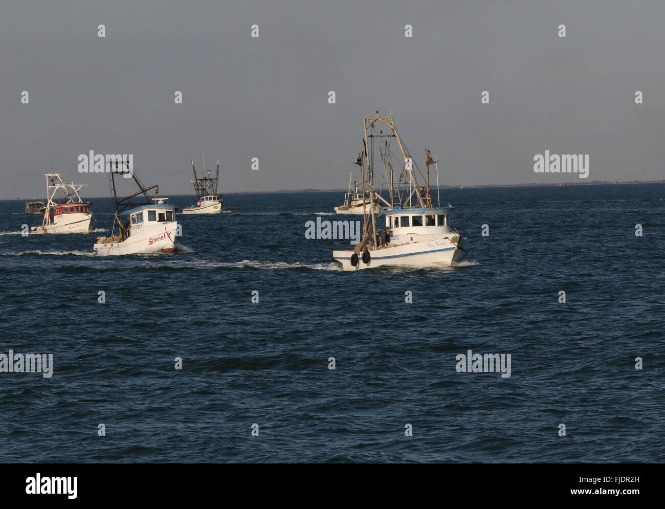 Oyster fishing boats returning to harbour harbor Stock Photo - Alamy