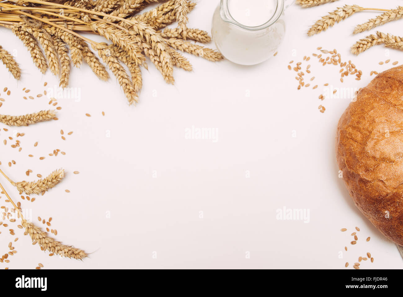 Milk, wheat grain and bread on white background Stock Photo - Alamy