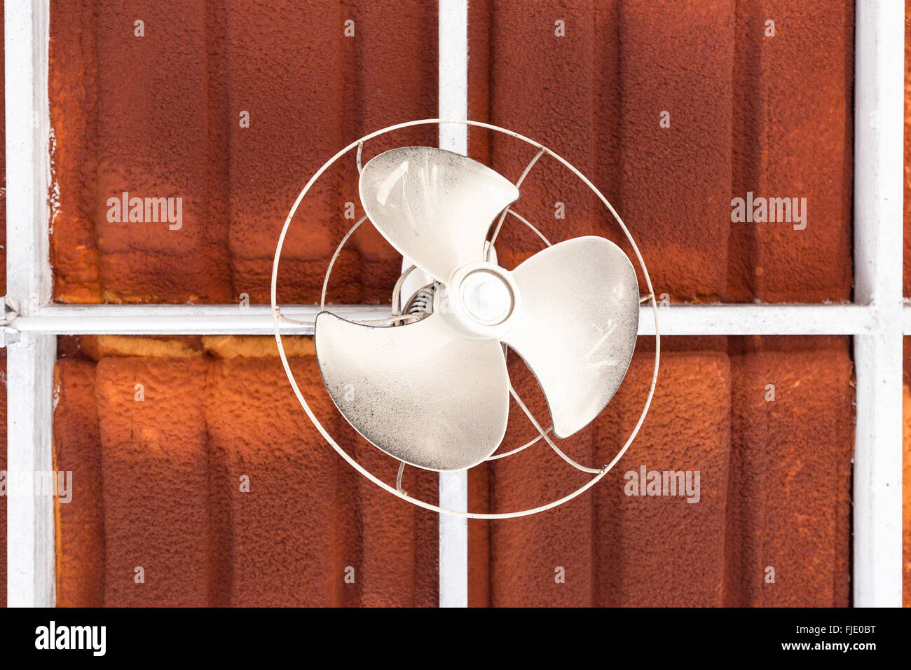 Old design of three-blade fan hung on the ceiling Stock Photo - Alamy